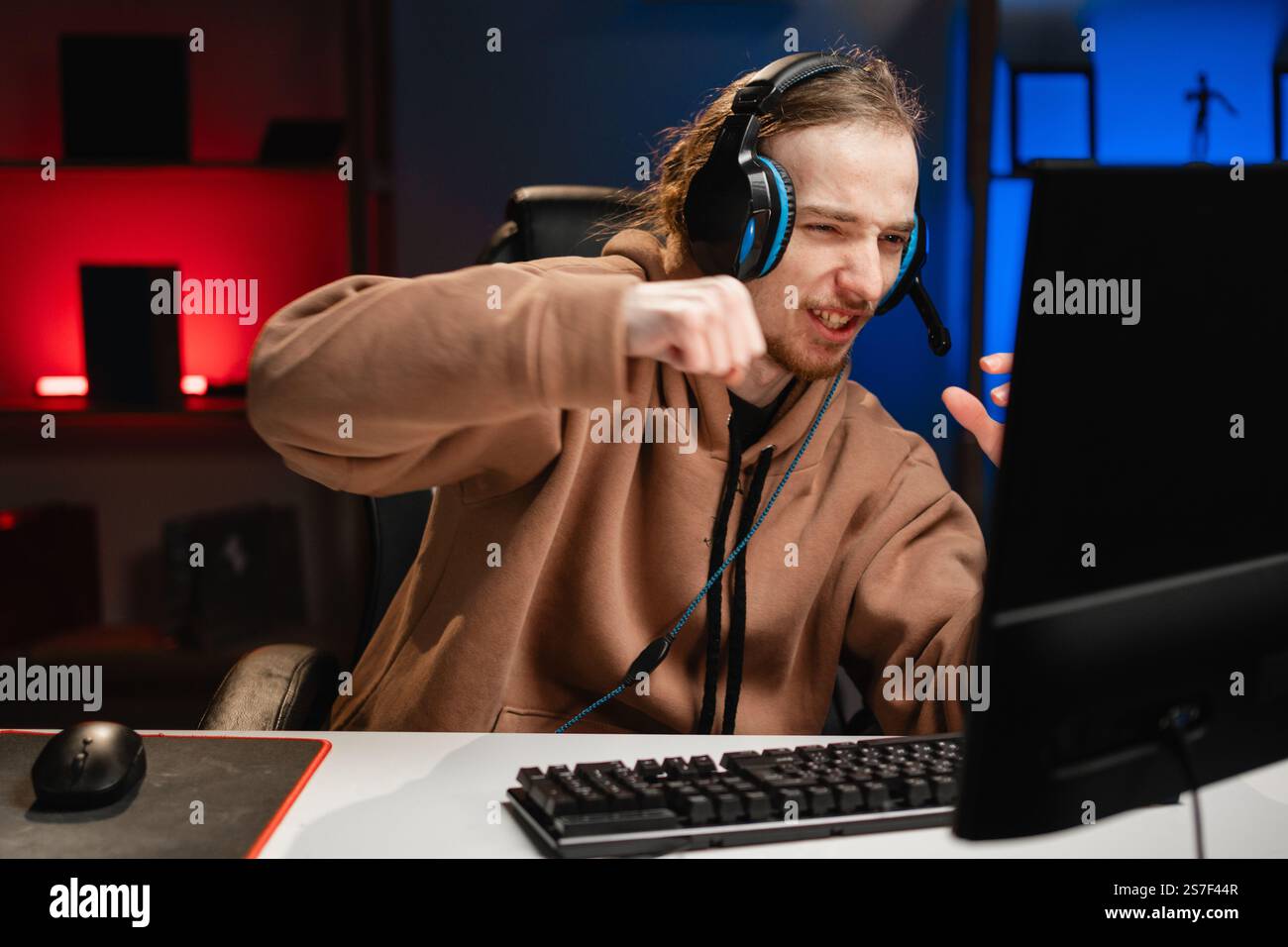 Aggressive young gamer streamer hosting a live broadcast at home at ...