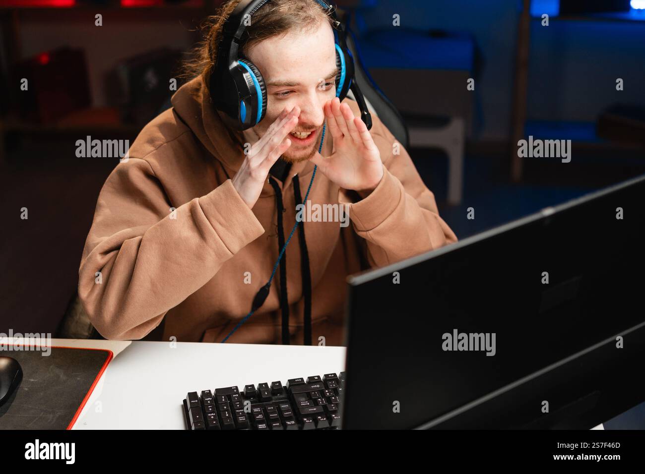 Gamer streamer playing computer games broadcasting stream at night at ...