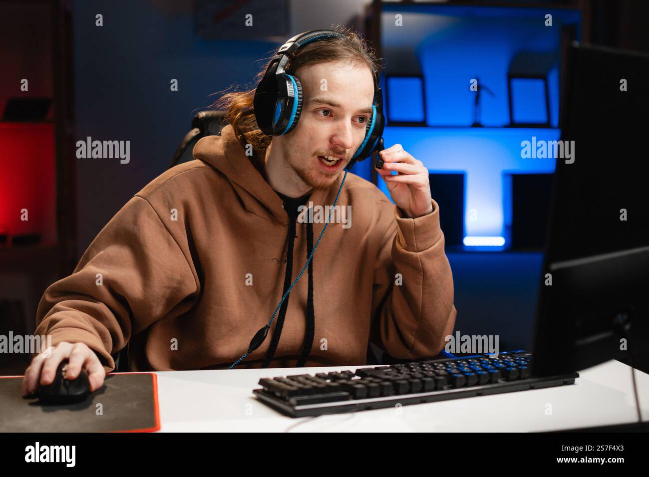 Streamer gamer playing online video games uses microphone to broadcast ...