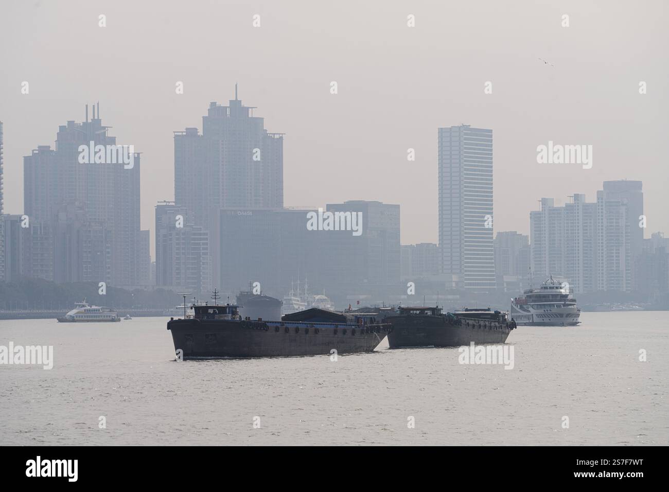 Shanghai, China. January 7, 2025. cargo ships transiting the Huangpu ...