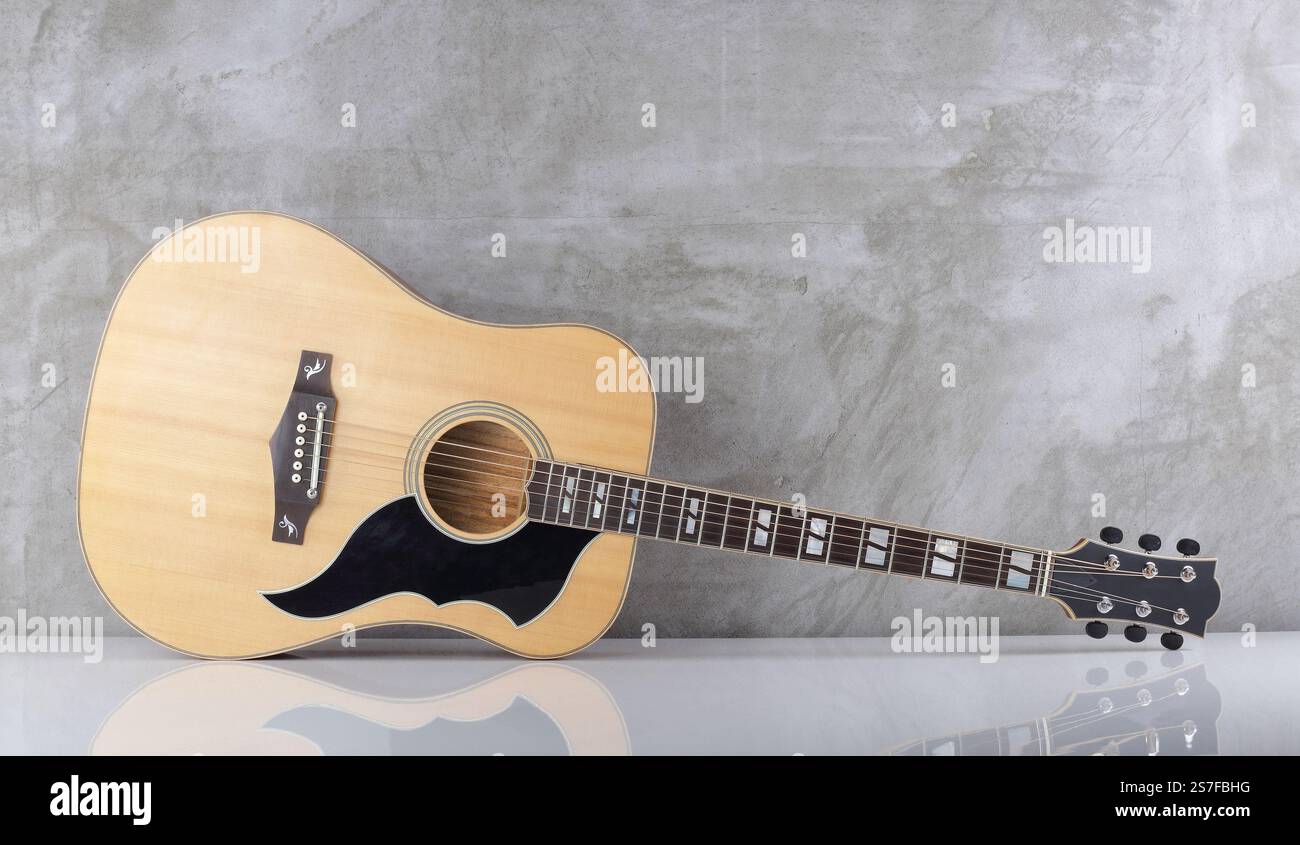 Musical instrument - Western acoustic guitar background of a concrete ...