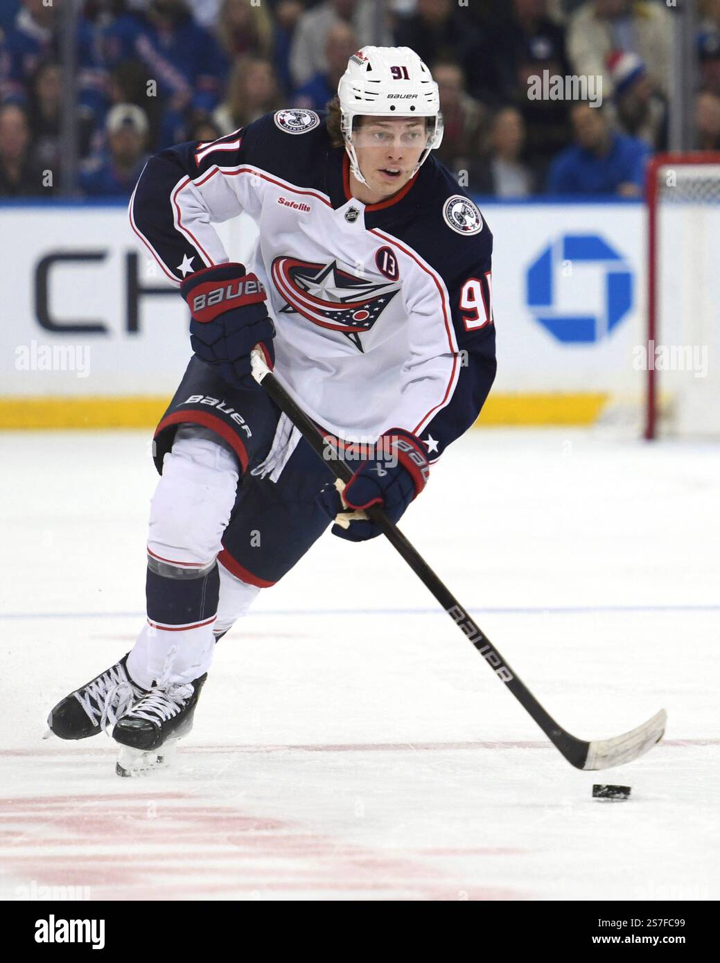 Columbus Blue Jackets' Kent Johnson skates with the puck during the ...