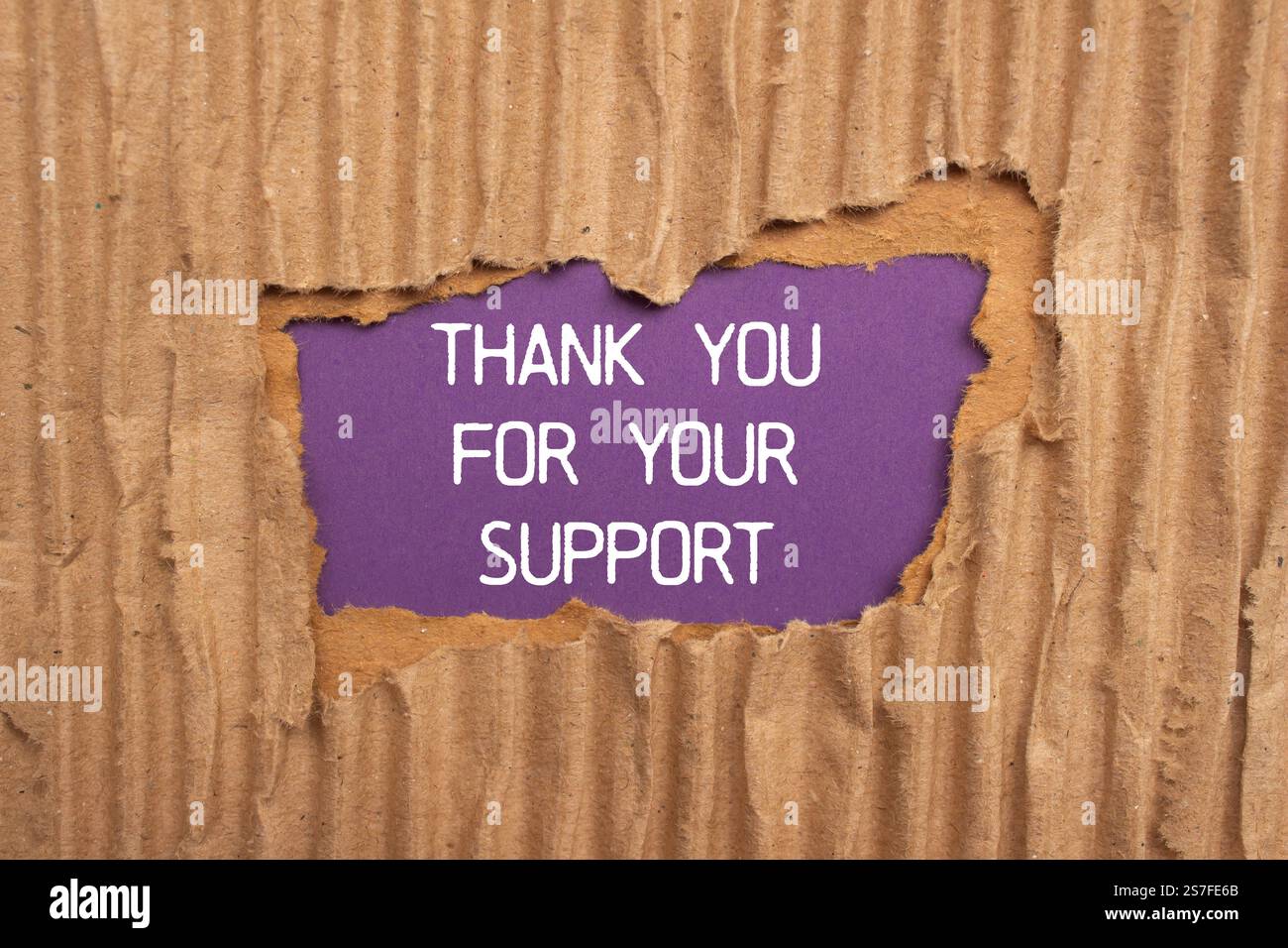 Thank you for your support message written on ripped torn cardboard ...