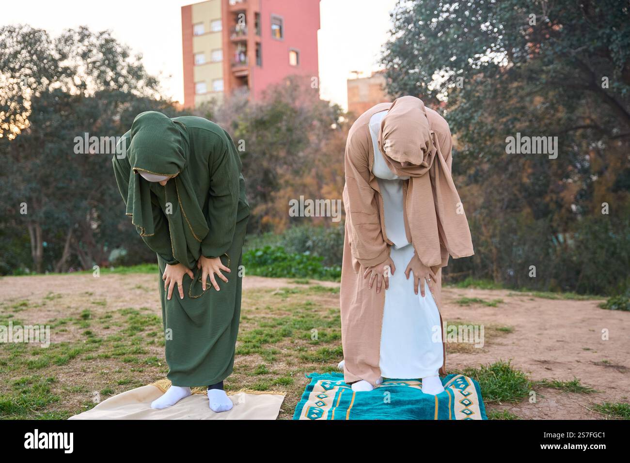 Two muslim women bowing during salat prayer outdoors Stock Photo - Alamy