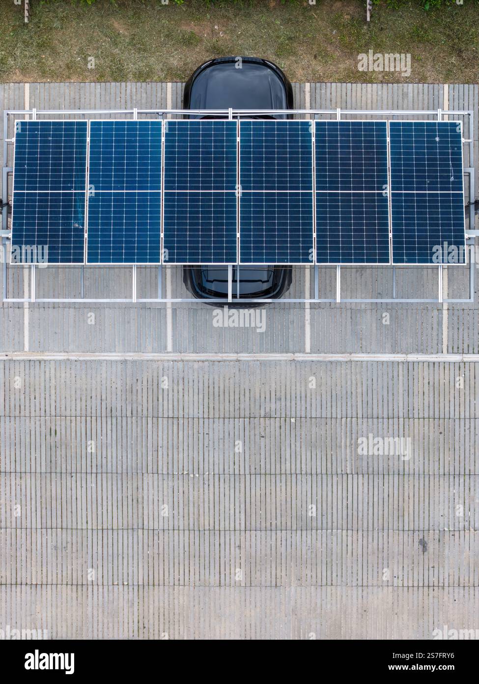 Effective photovoltaic solar panel installation over a parked black ...