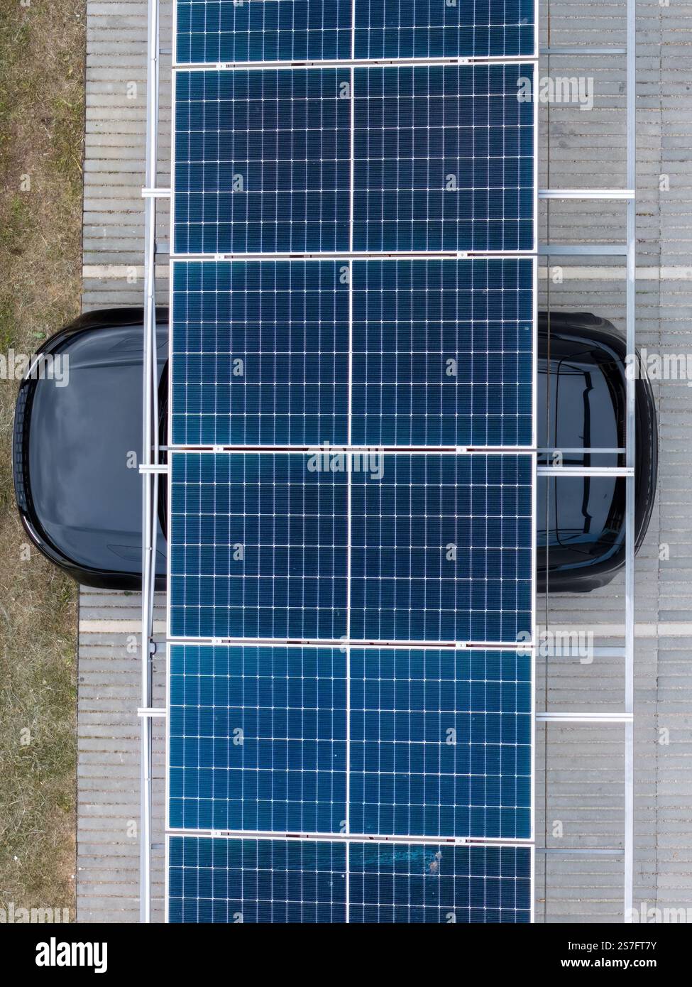 Effective photovoltaic solar panel installation over a parked black ...