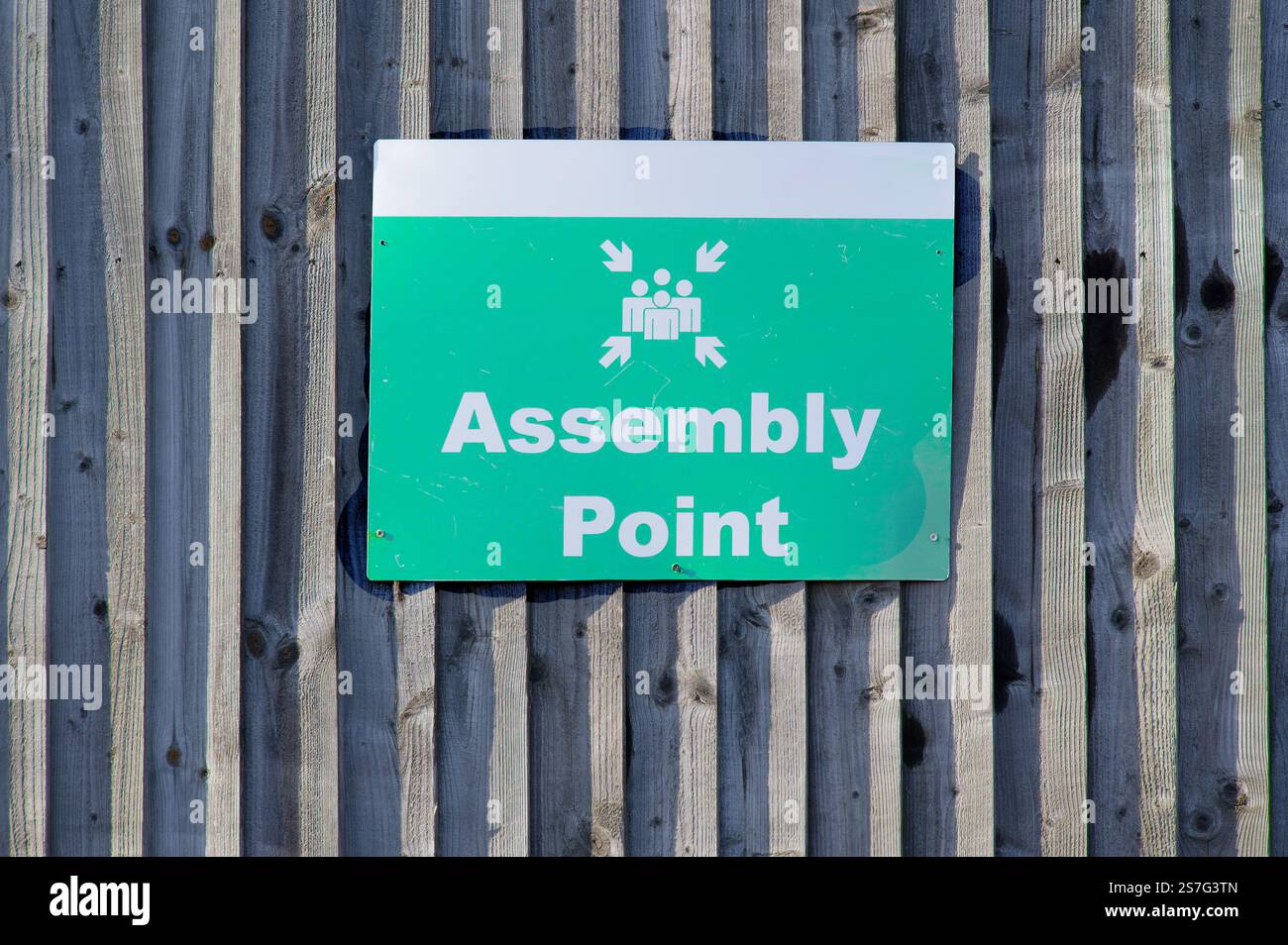 Fire assembly point sign at workplace signpost Stock Photo - Alamy