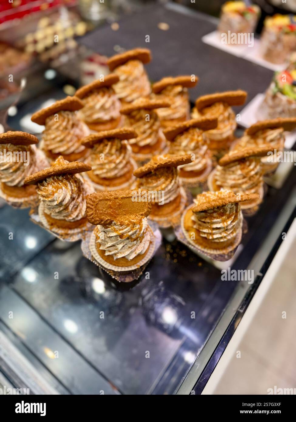 Biscuit cupcake with cream decoration at showcase of bakery for sale ...