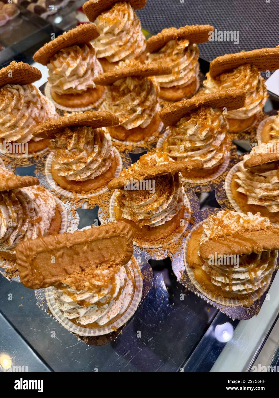 Biscuit cupcake with cream decoration at showcase of bakery for sale ...