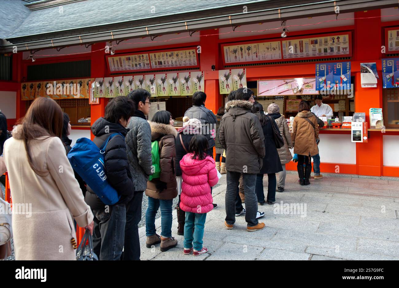 People standing in a queue to purchase New Year good luck amulets and ...