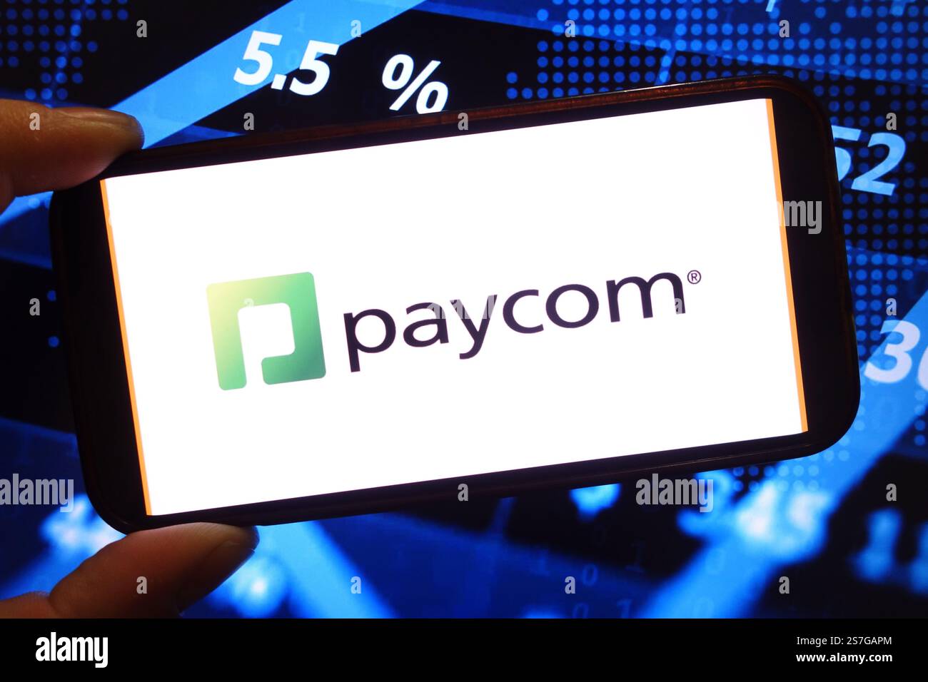 In this photo illustration, the Paycom company logo is seen displayed ...
