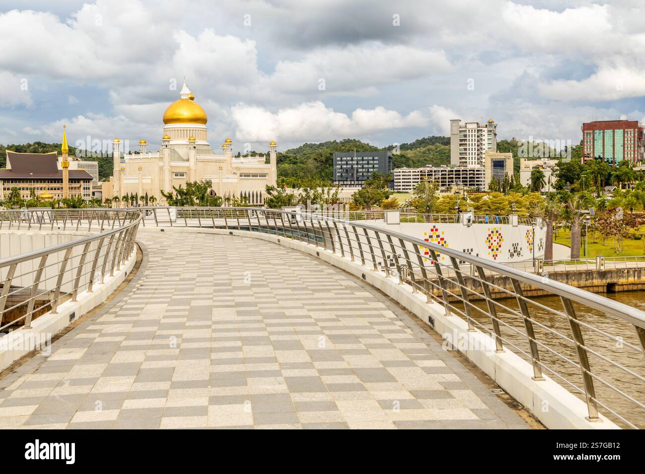 Pedestrian bridge with Omar Ali Saifuddien Mosque golden domes and ...