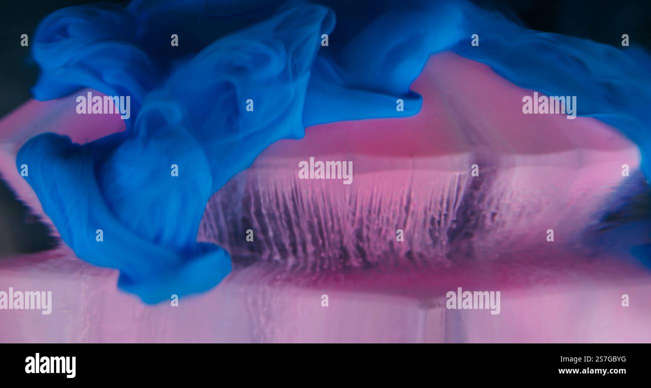 Ink pouring. Mist paint. Pink purple wave smoke particles floating ...