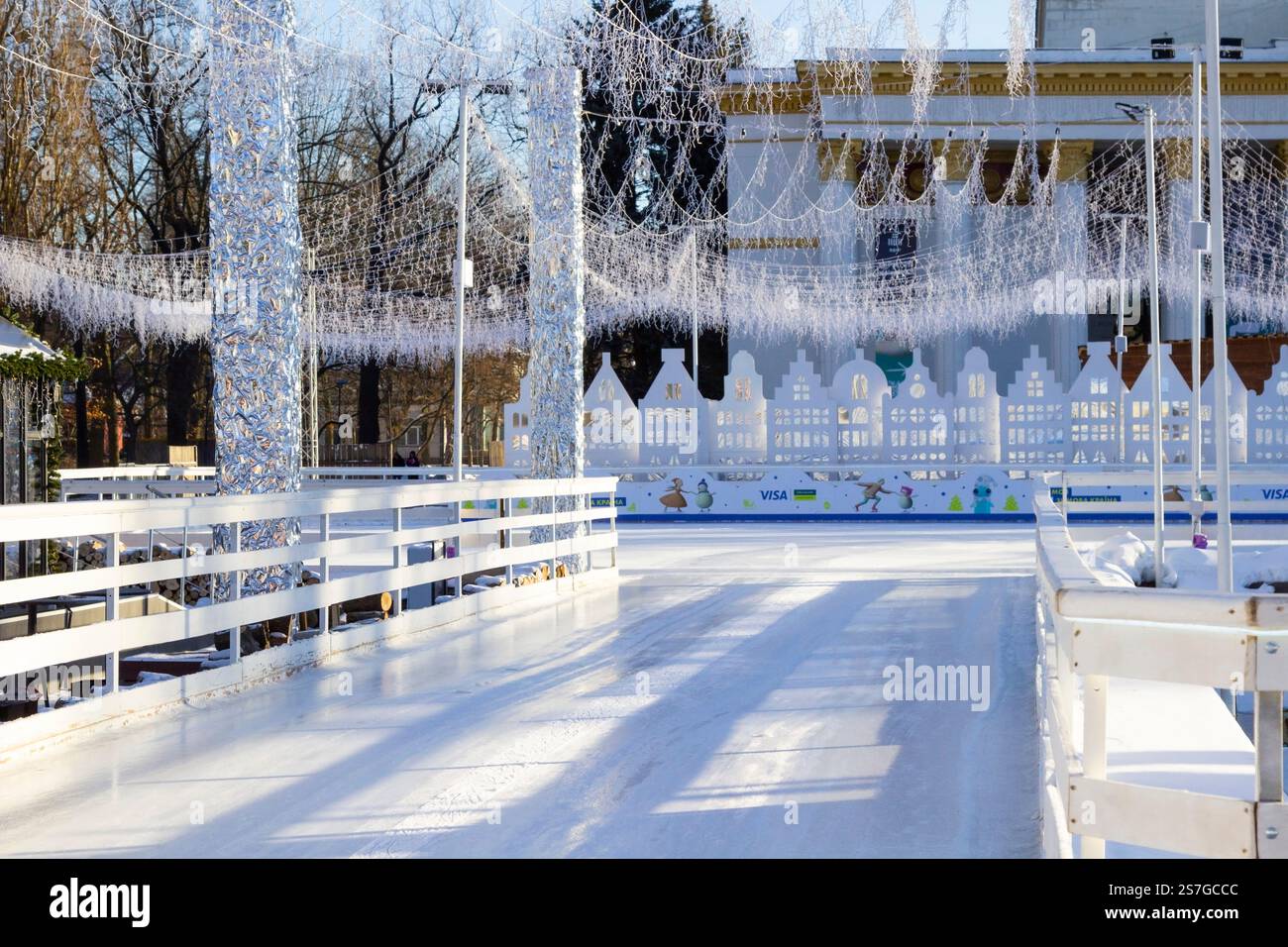 A skating rink decorated with festive illuminations. An ice track and ...