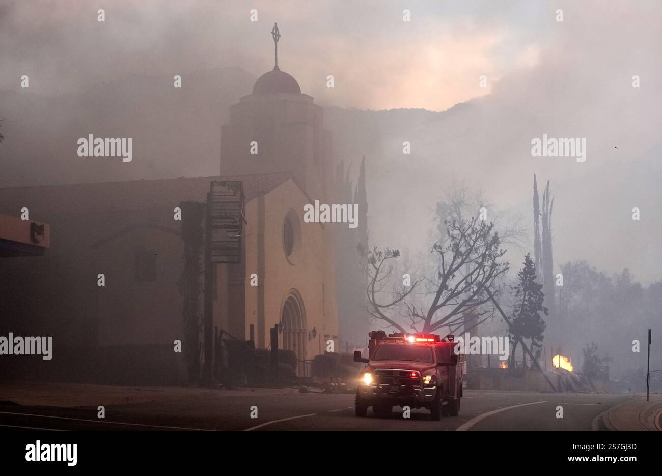 A fire truck drives down Altadena Drive past the Altadena Community ...