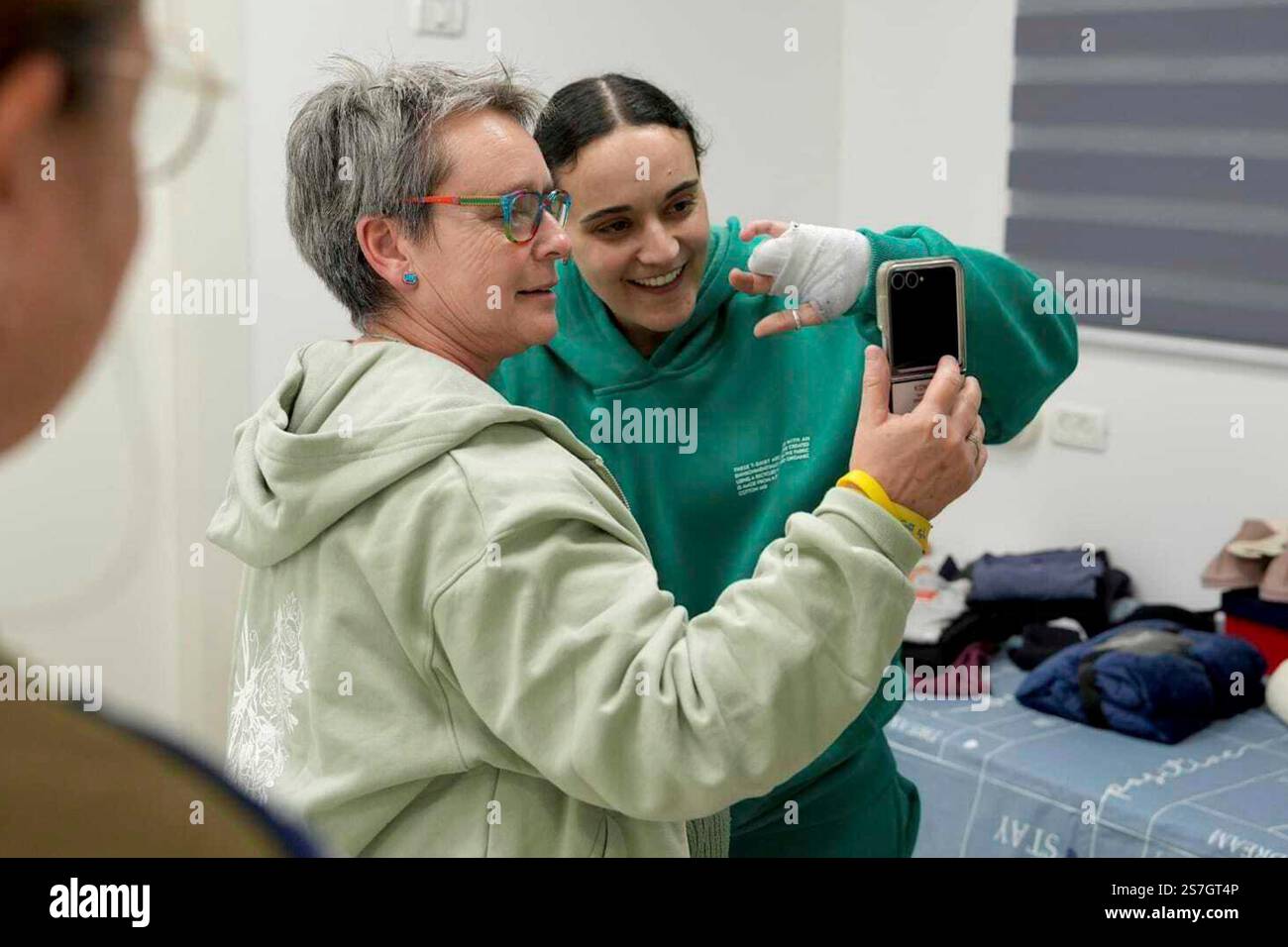 In this photo released by the Israeli Army, Emily Damari, right, and ...
