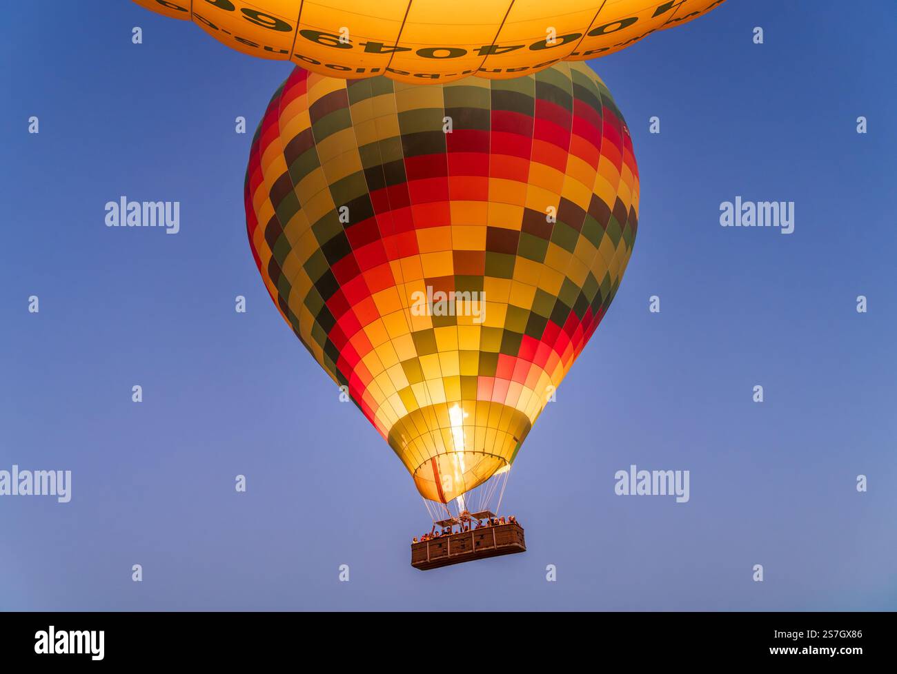 Large hot-air balloon rising from ground over Sahara desert and Valley ...