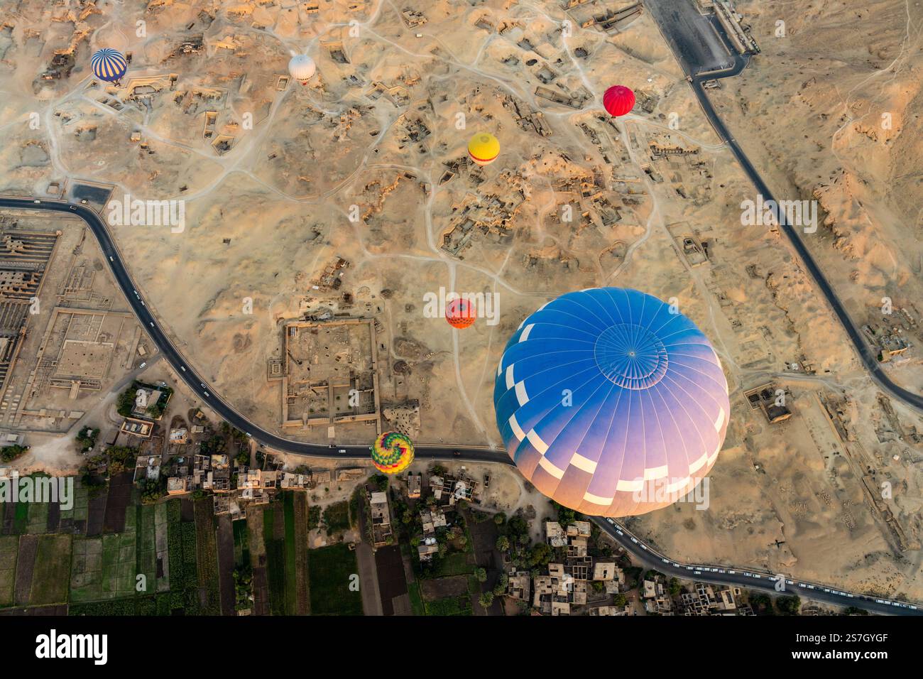 Large hot-air balloon rising from ground over Sahara desert and Valley ...
