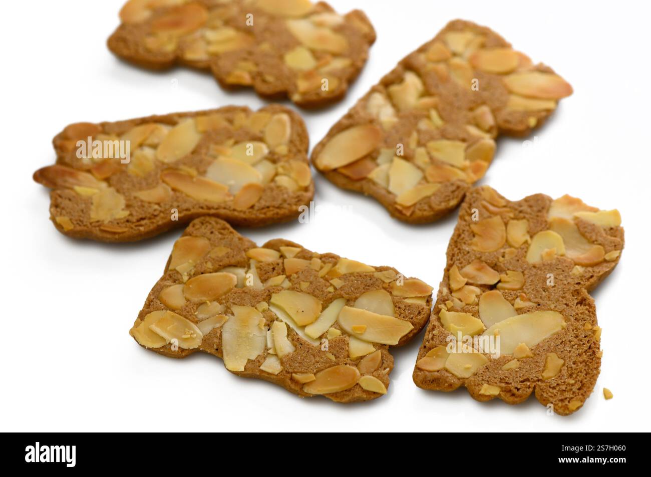 Five crunchy almond cookies are beautifully arranged, showcasing their ...