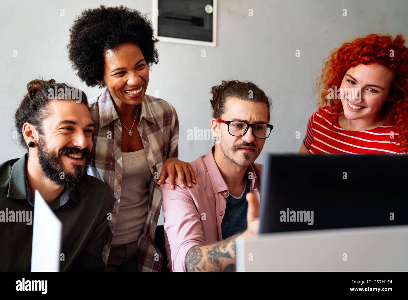 Mixed team of software engineers brainstorming ideas. Diverse app developers collaborating as ...