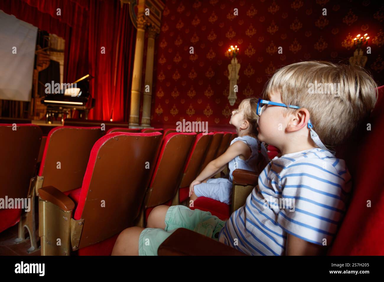 Two kids watch a stage set for an event, full of anticipation Stock ...
