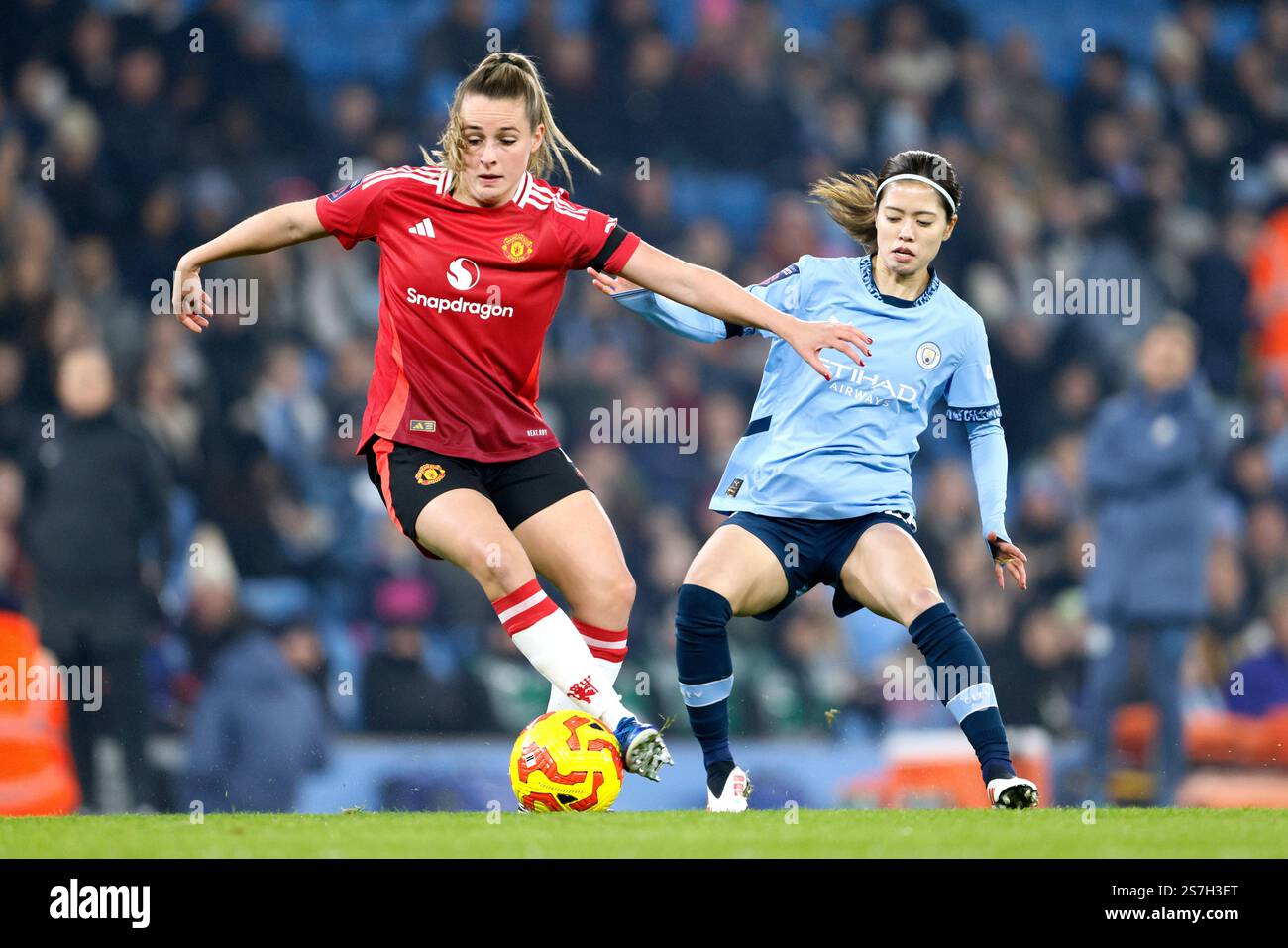 Manchester United's Ella Toone (left) and Manchester City's Aoba Fujino ...