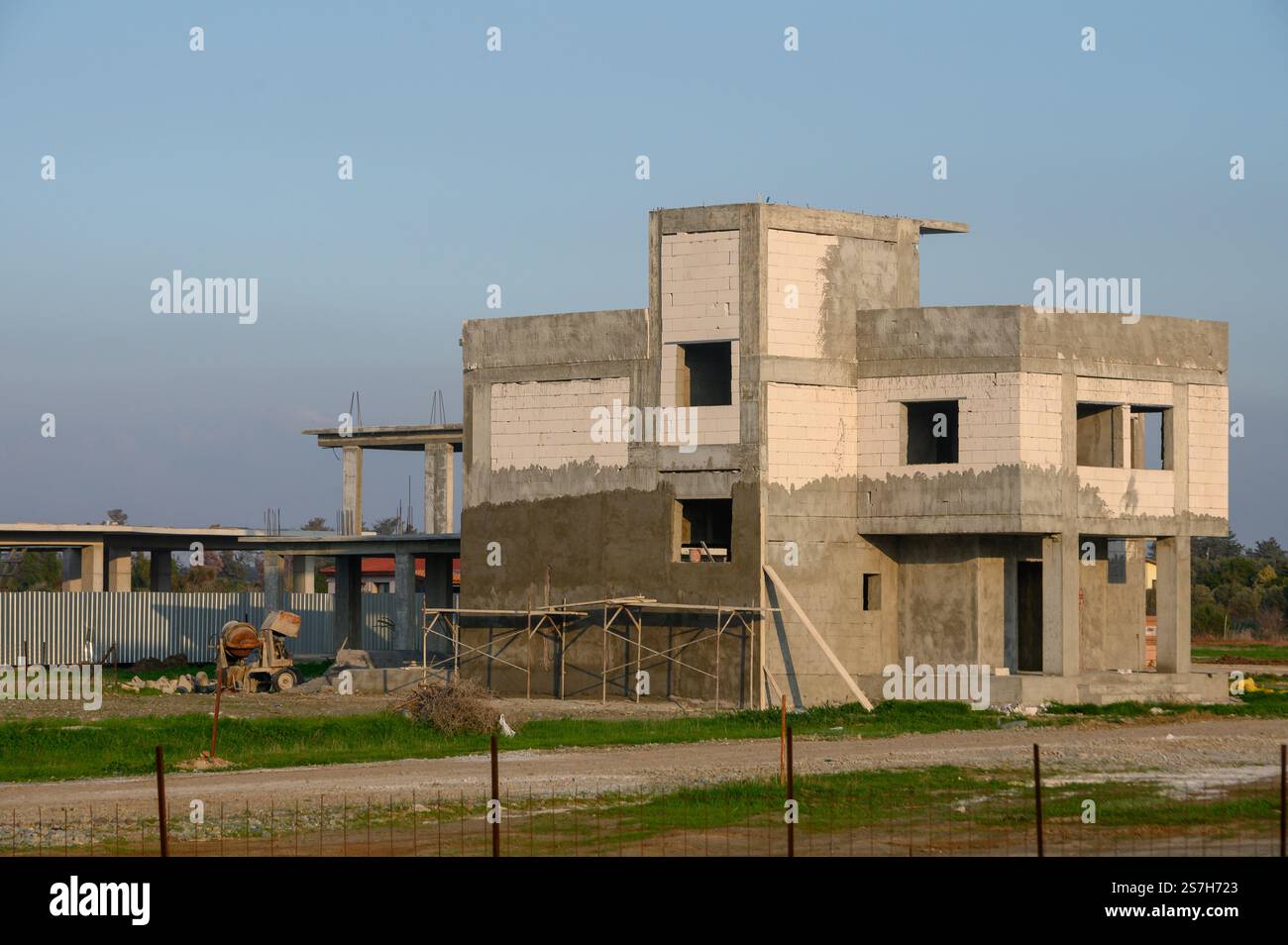 Progress of a contemporary building rises amid the open fields, marking ...