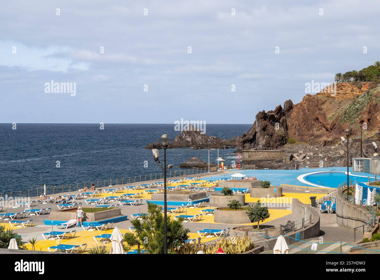 People enjoying the swimming pool at Funchal city in Madeira Island ...