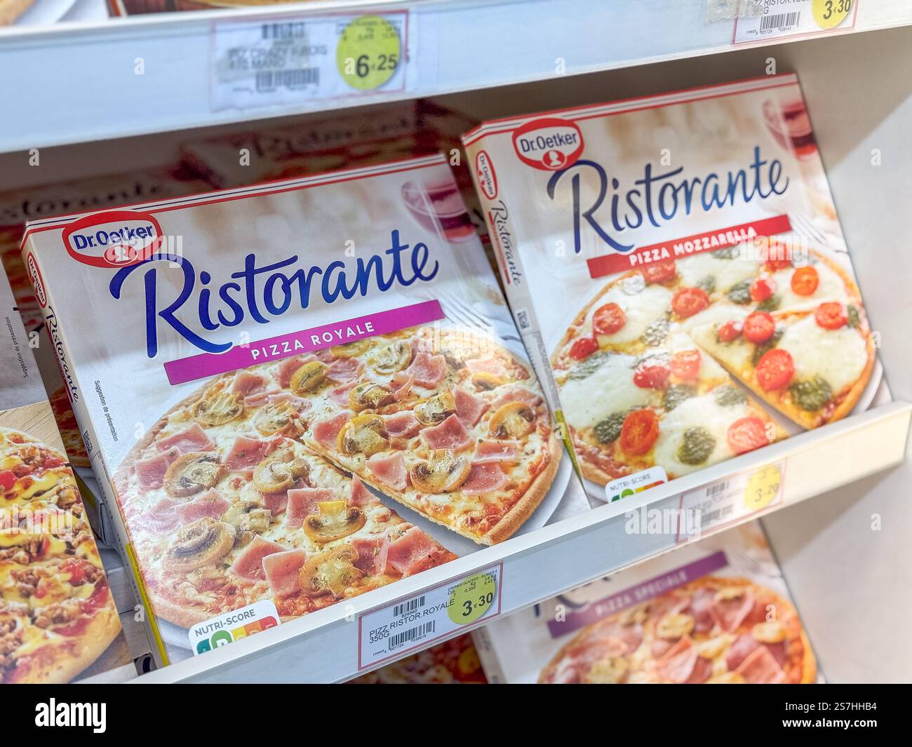 Frozen pizza varieties on display in a grocery store aisle in the ...