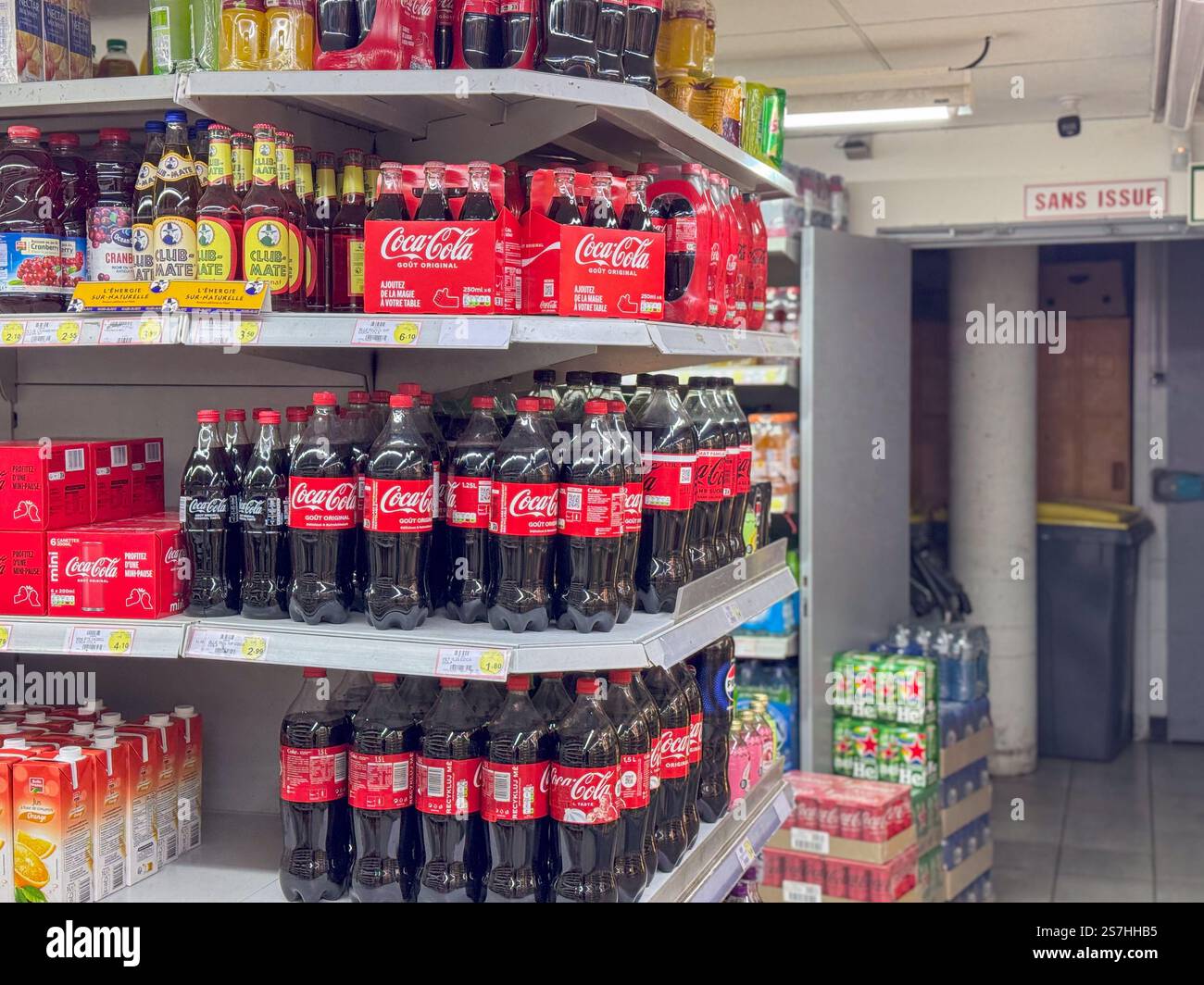 Coca-Cola bottles displayed on shelves in a convenience store Stock ...