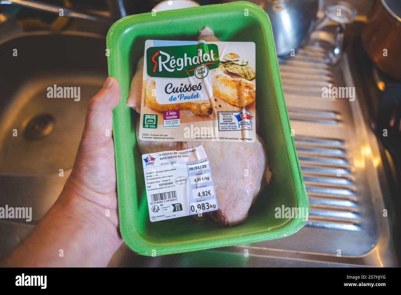 Couple preparing a meal with chicken thighs in kitchen sink area Stock ...