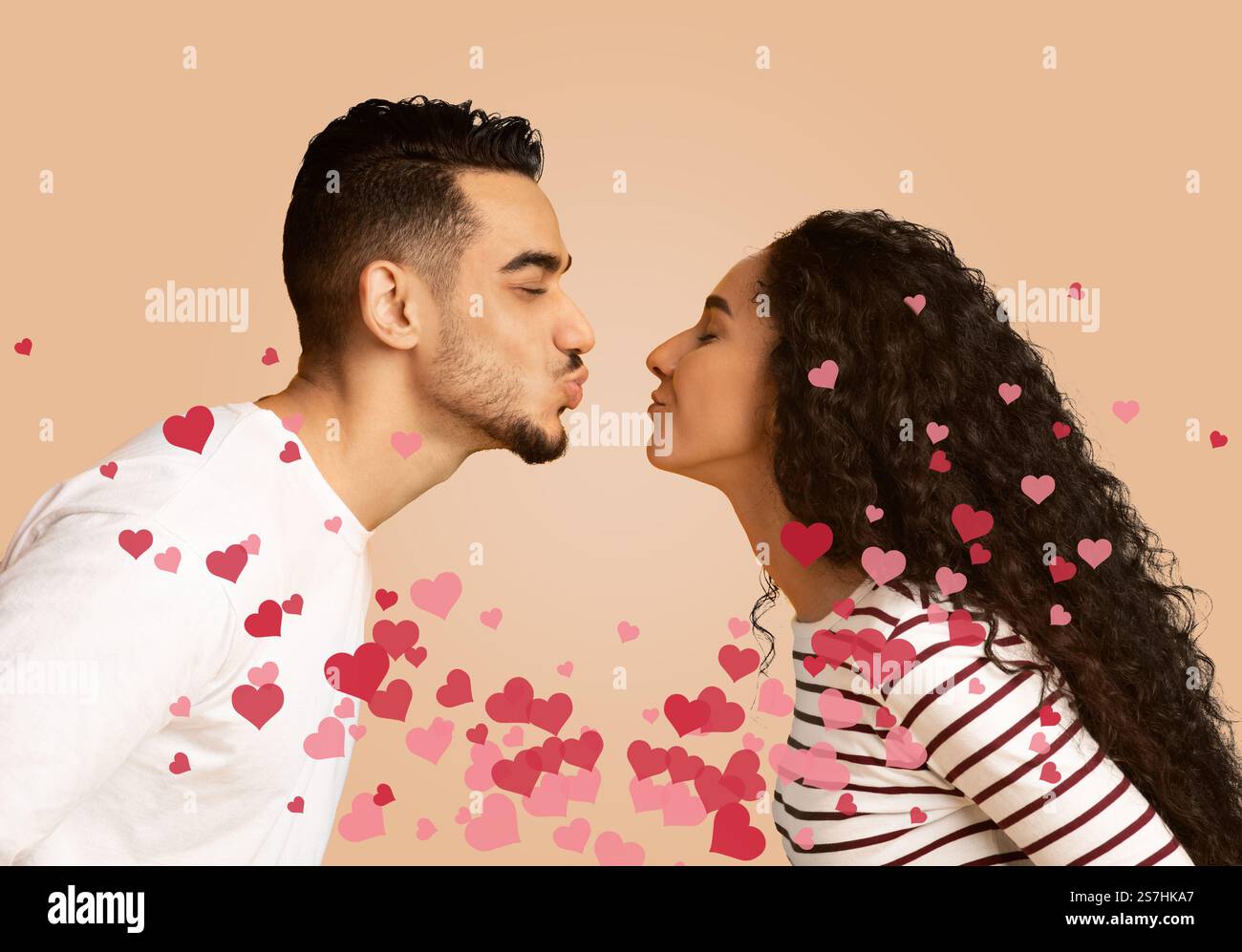 Couple sharing a loving kiss with hearts for Valentine's Day ...