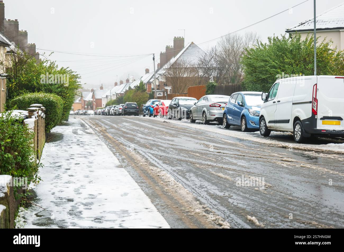 Frost snow covered british road and cars in england uk Stock Photo - Alamy