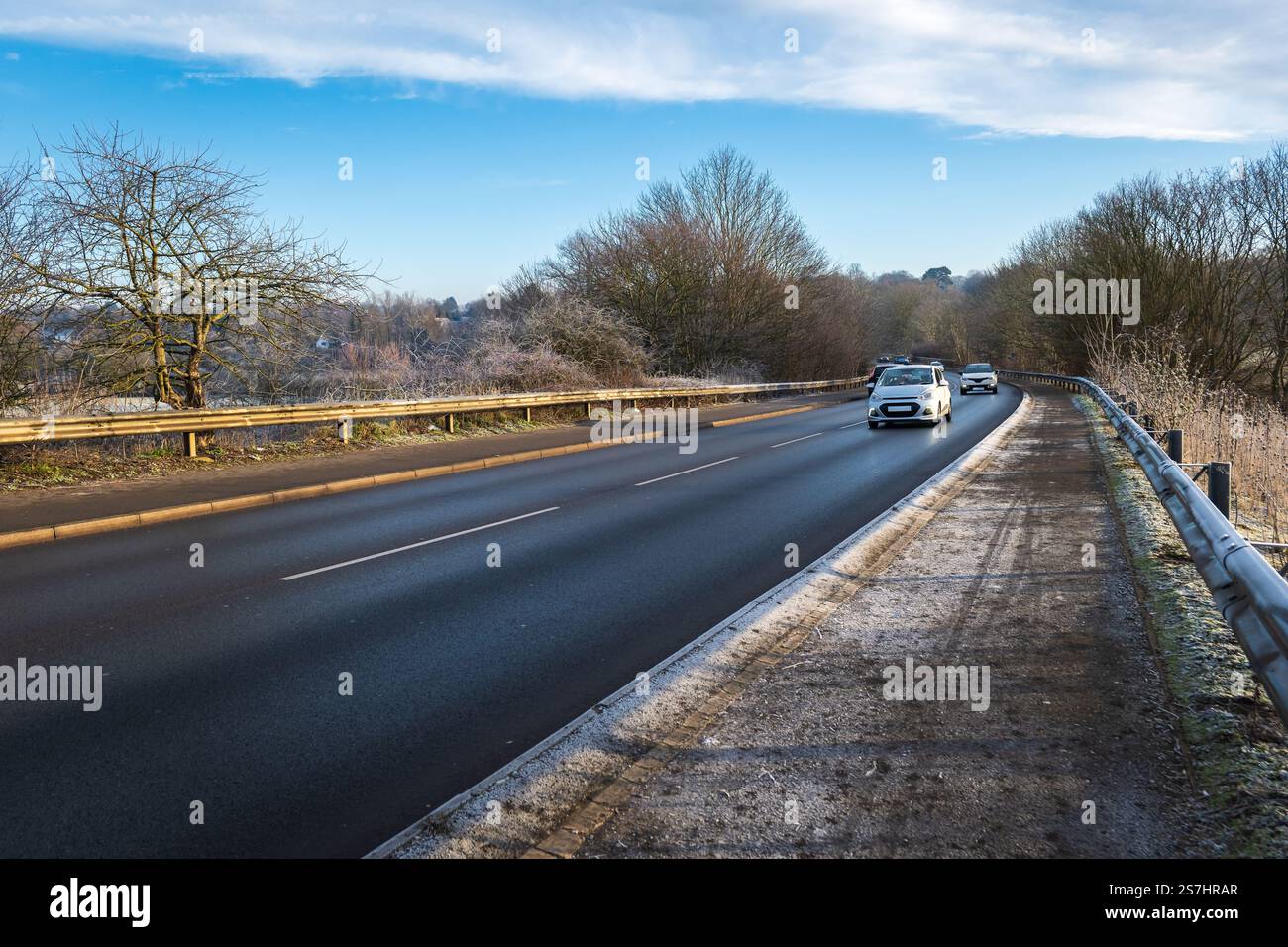 Frost snow covered british road and cars in england uk Stock Photo - Alamy