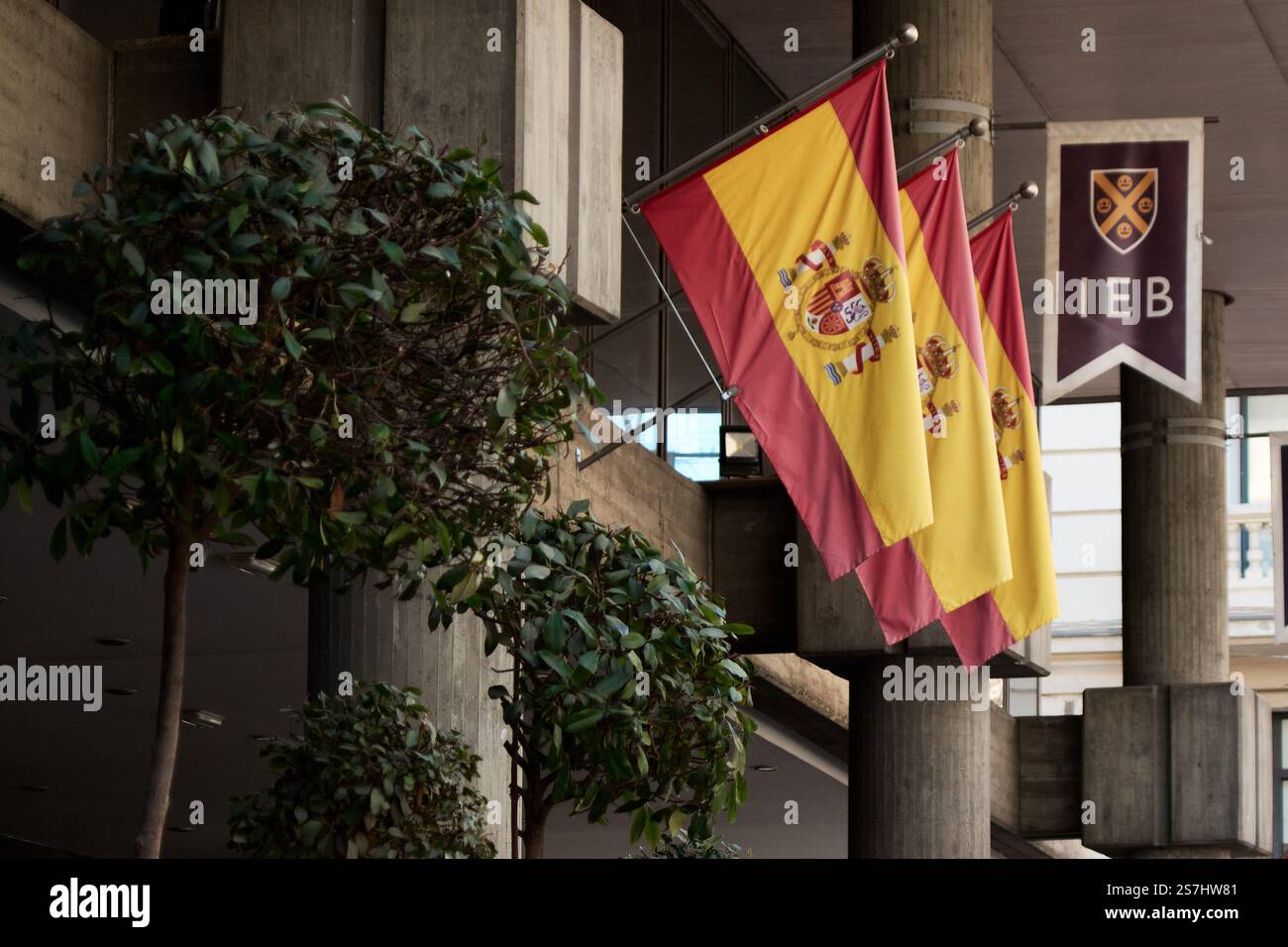 Madrid. Spain - January 19, 2025: Spanish flags and an IEB banner on a ...