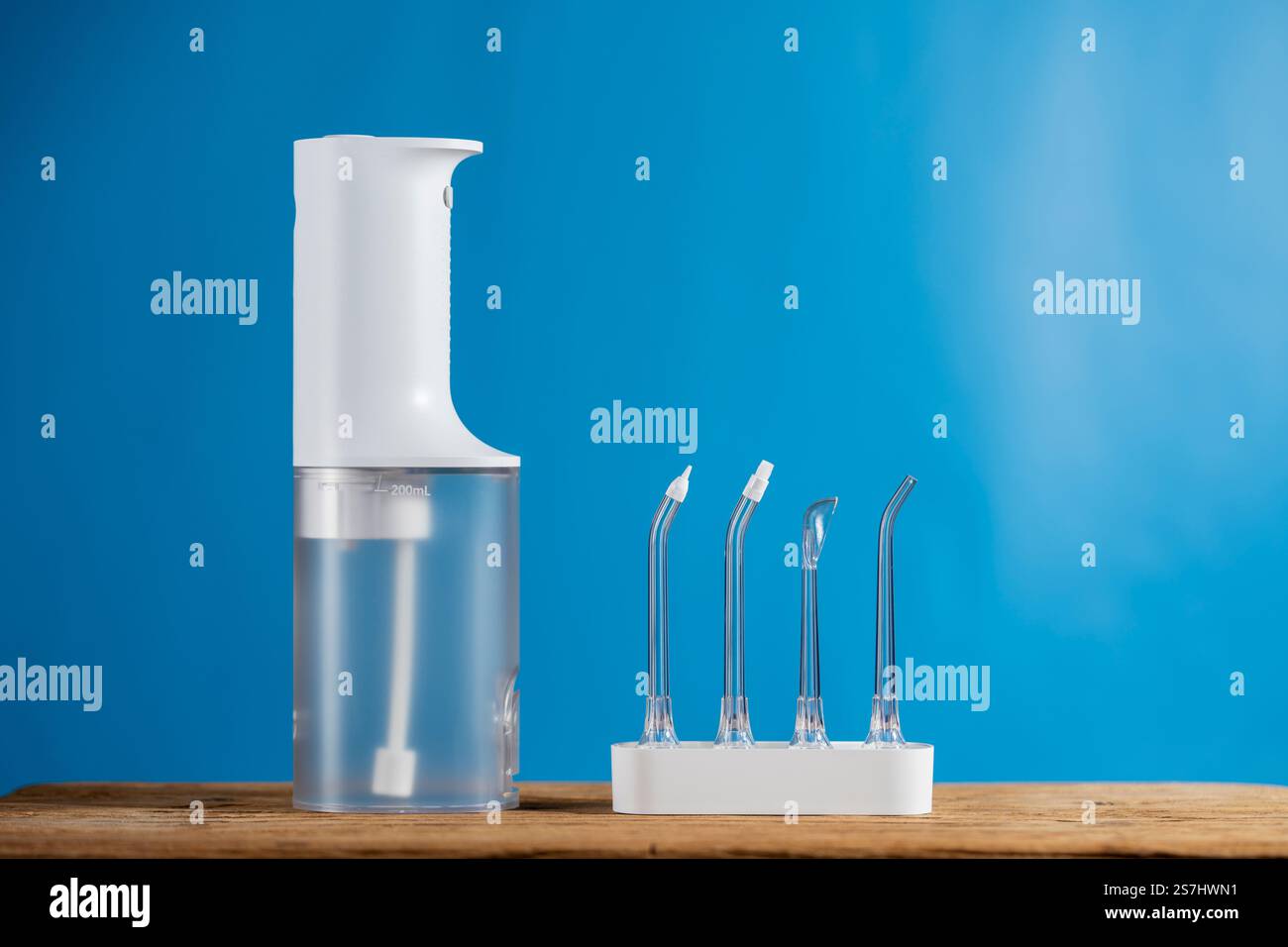 Portable oral irrigatoron blue background, close up. Dental teeth ...