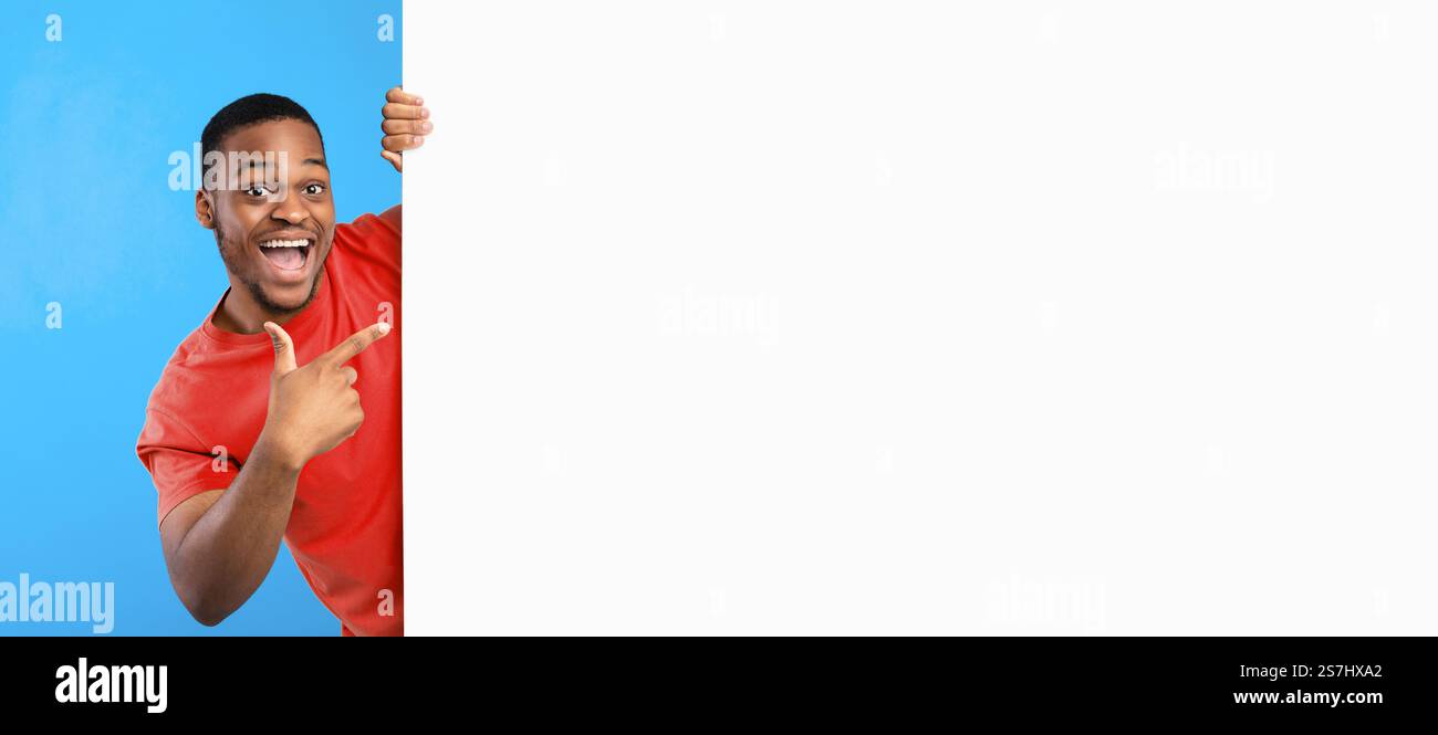 Excited African Man Pointing Finger At Paper Poster, Blue Background ...