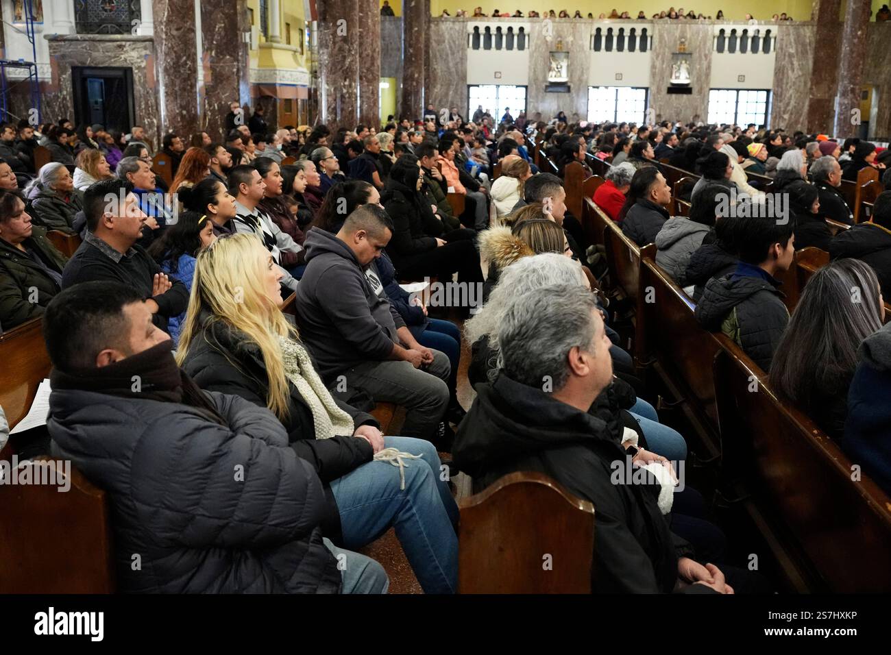 Church members listen to priest Homero Sanchez during a service at St ...