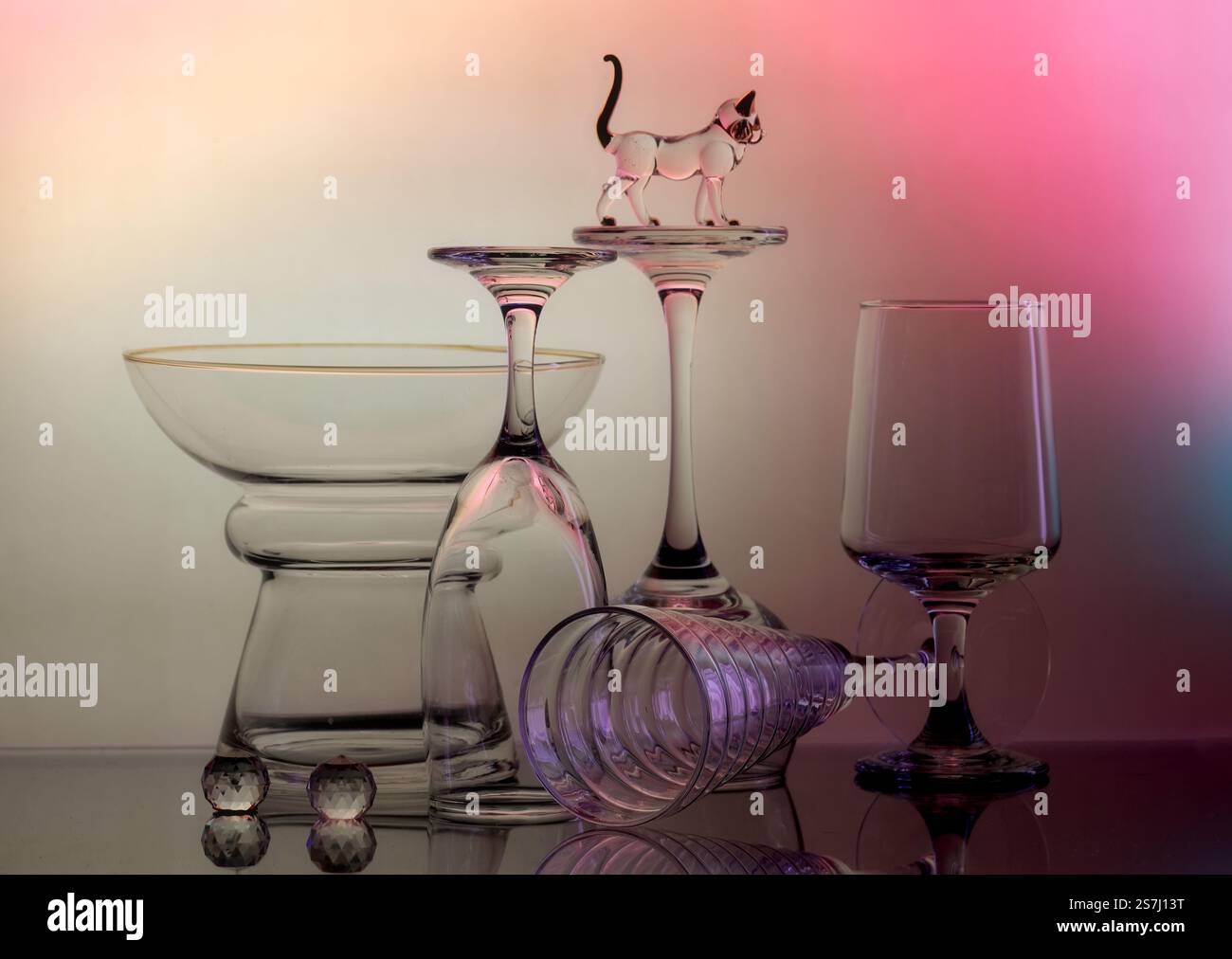 Glassware and decoration objects on a colorfully lit background Stock ...