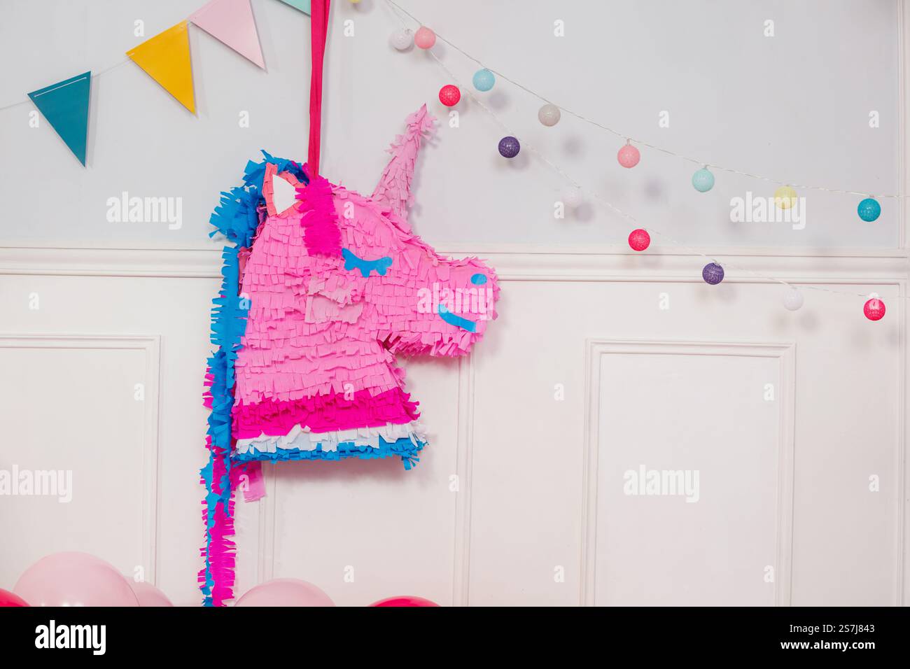 Majestic pink unicorn pinata and bunting bring joy to the party Stock ...