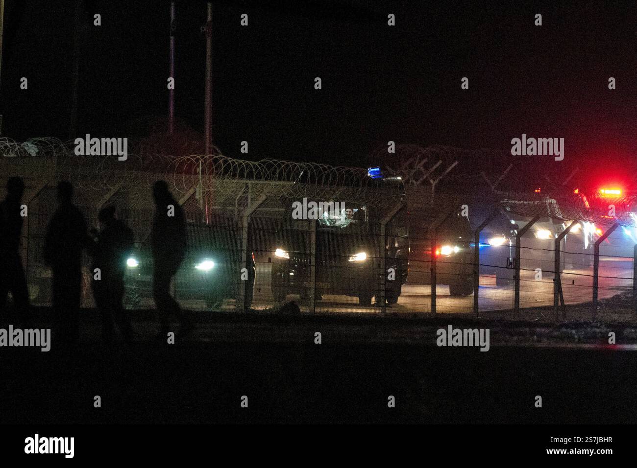 A convoy of vans and military vehicles carrying the released hostages ...