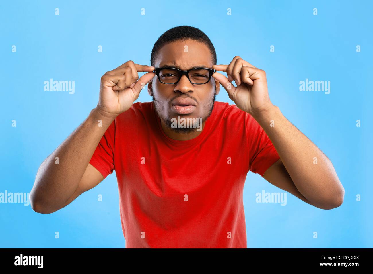 African American Guy With Poor Eyesight Squinting Eyes, Blue Background ...