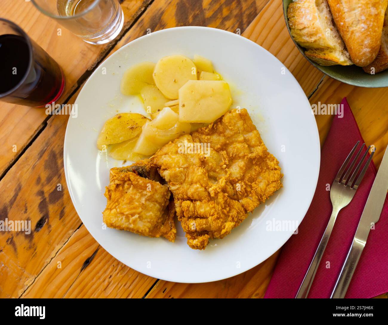 Fried cod fillet in crispy breading with potatoes Stock Photo - Alamy