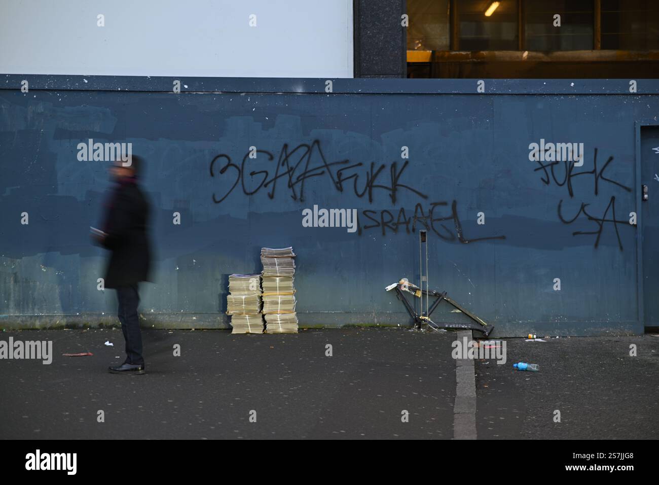 Urban Scene With Pro-Palestine Graffiti on a Wall and a Passing ...