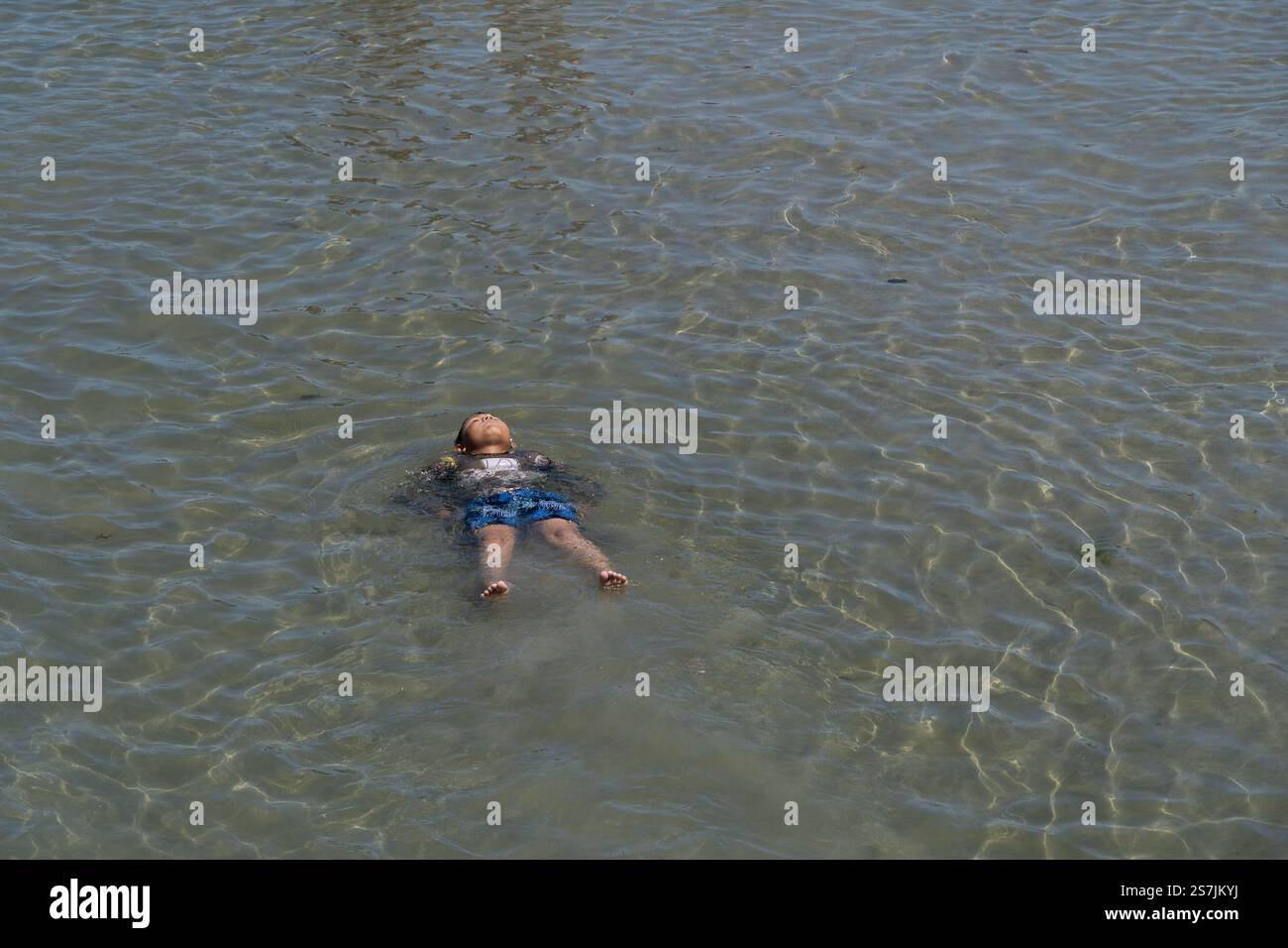 Tongoy, Santiago, Chile. 19th Jan, 2025. Children swim at the beach of ...