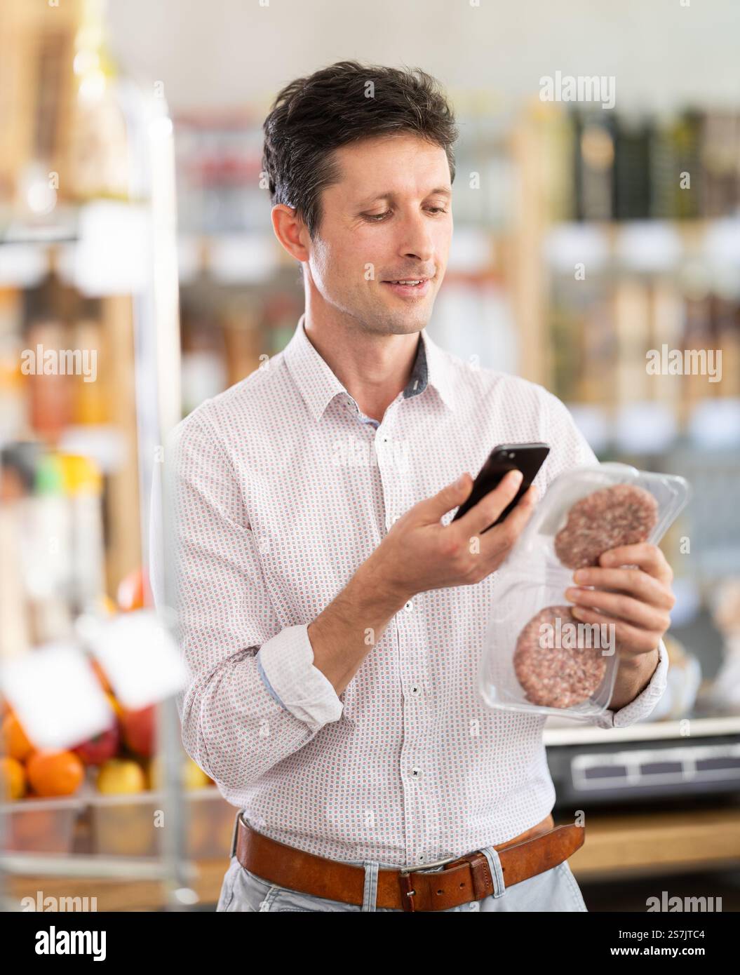 Adult man scanning qr code of raw hamburger Stock Photo - Alamy