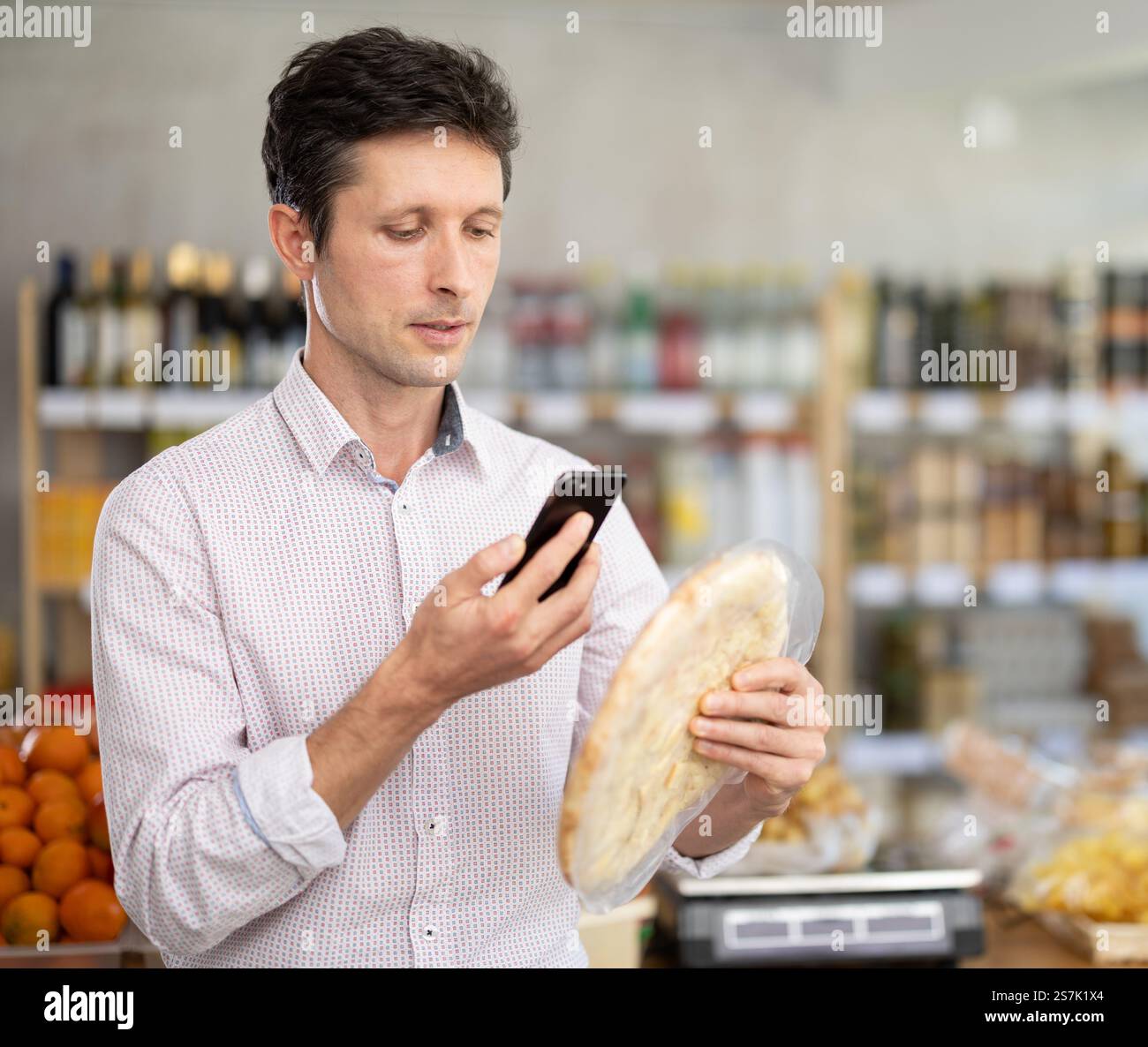 Adult man scanning qr code for four cheese pizza Stock Photo - Alamy