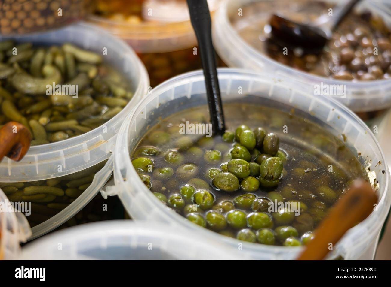 Heap of green olives with pits in buckets Stock Photo - Alamy