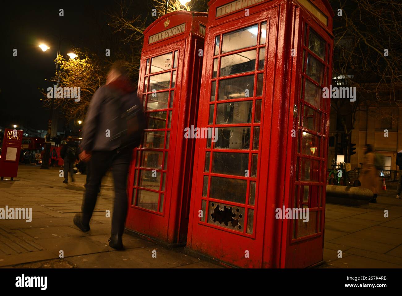 Iconic British Red Telephone Booths on a Busy Night Street Stock Photo ...