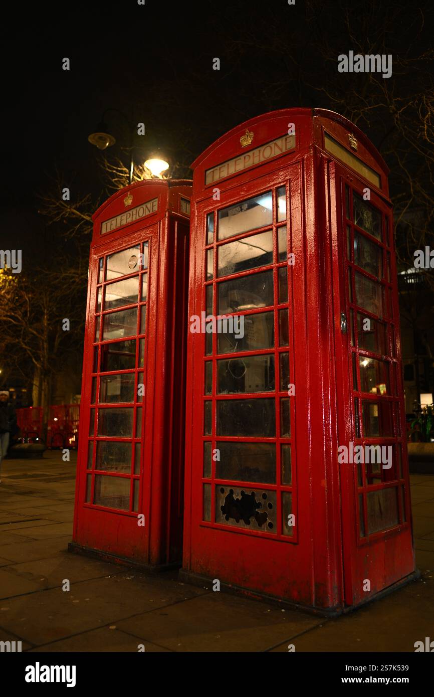 Iconic British Red Telephone Booths on a Busy Night Street Stock Photo ...